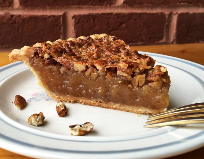 Pecan pie perfection—glistening filling topped with a mosaic of nuts. One bite and you'll understand why people drive across counties for this.