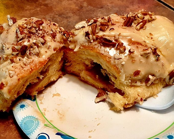Behold the pecan roll—where maple glaze cascades over pillowy dough like a sweet waterfall, with crunchy nut confetti celebrating your excellent life choices.