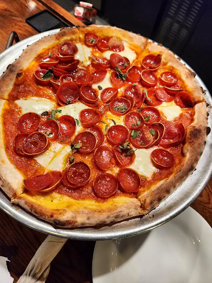 Pepperoni that curls into little flavor cups, collecting precious oils like tiny edible chalices. This isn't just pizza – it's architecture with attitude.