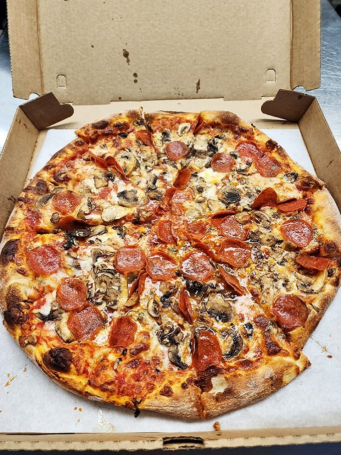 Pizza perfection doesn't need fancy toppings—just the classics done right, with cheese that stretches like it's auditioning for the Olympics.