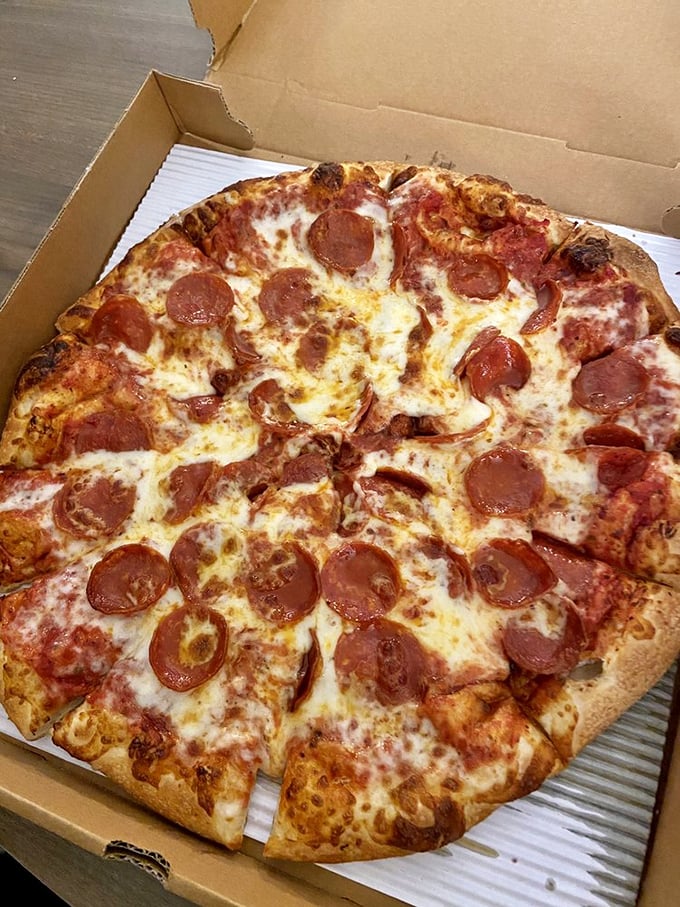 The pepperoni pizza that launched a thousand cravings – each slice a perfect ratio of crispy-chewy crust, tangy sauce, and those little cups of pepperoni magic.