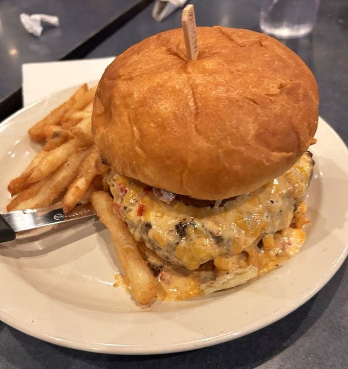 This isn't just a burger—it's a towering monument to excess that requires both hands, several napkins, and absolutely zero regrets.