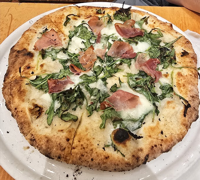 Even their pizza gets the farmhouse treatment – a crispy canvas of dough adorned with prosciutto and greens that somehow feels both rustic and sophisticated.