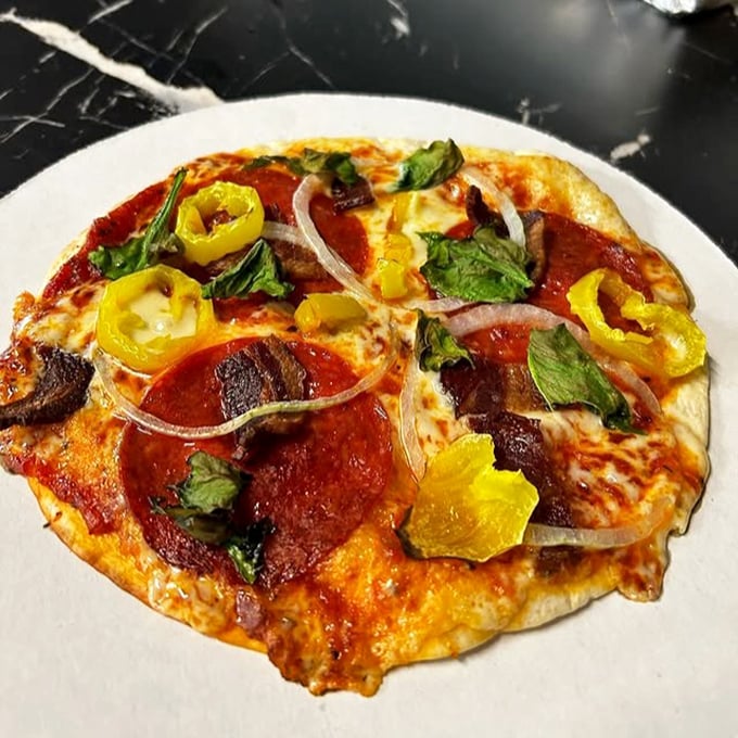 Pizza that proves you don't need to be in Naples to find happiness – just the right balance of cheese, toppings, and that essential char.