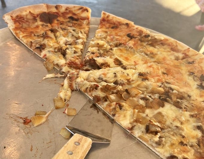 The mushroom pizza slices are halfway gone because waiting for the camera was simply asking too much of human willpower.