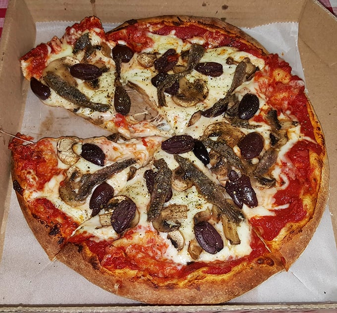 Even the pizza gets the smoky treatment here. Those mushrooms and olives aren't just toppings—they're supporting actors in a wood-fired drama.