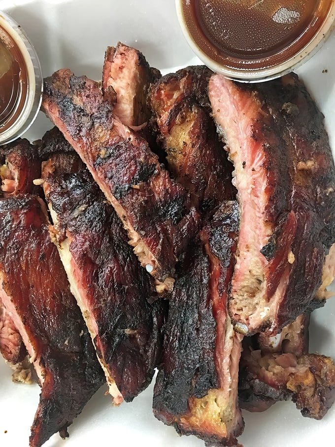 These ribs showcase that perfect smoke ring every pitmaster dreams about achieving in their backyard.