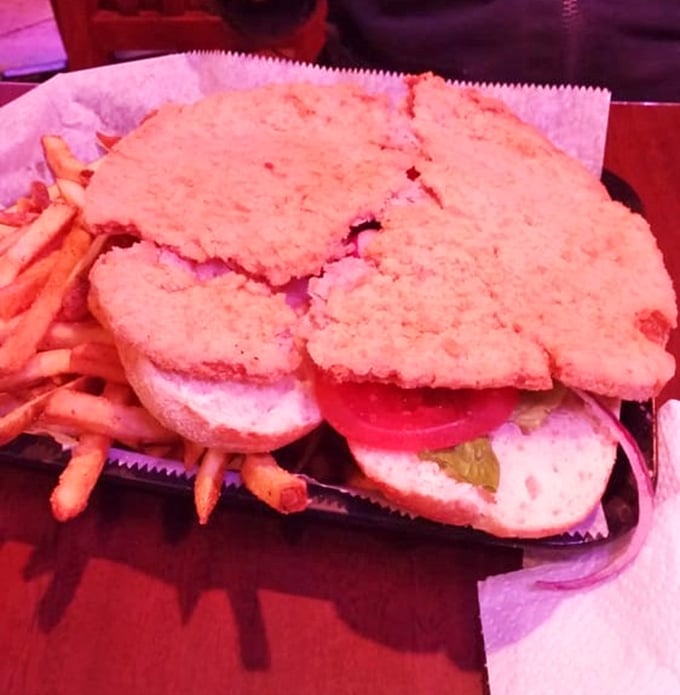 The tenderloin sandwich that makes Indiana proud—crispy, oversized, and requiring both hands and possibly a strategy meeting before consumption.