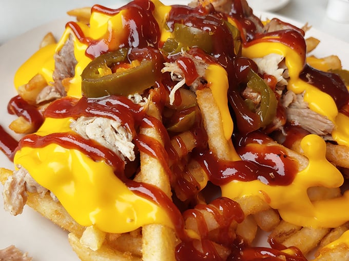 Loaded fries that don't know the meaning of restraint—cheese sauce and pulled pork engaged in a delicious tug-of-war for your taste buds' attention.