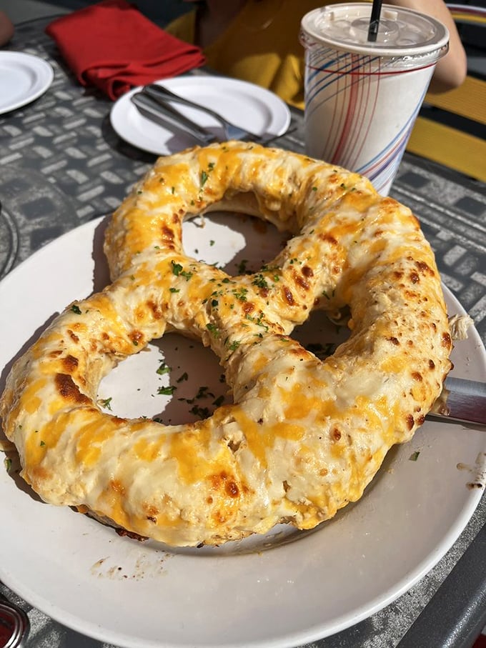 This isn't just any pretzel—it's a cheese-covered life preserver for the hungry soul. Dive in! 