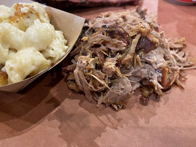 This pulled pork and mac & cheese combo isn't just comfort food—it's like getting a warm hug from your grandmother, if she were a BBQ pitmaster.