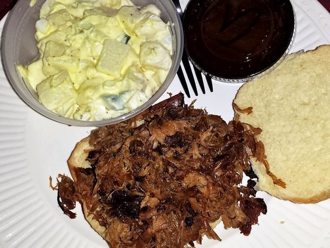 Pulled pork that's had a proper introduction to smoke, alongside potato salad and cornbread. This plate doesn't need a fancy description – it needs a fork.