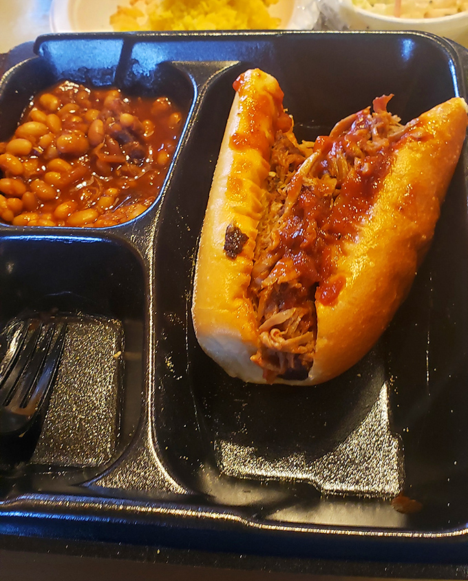 A pulled pork sandwich and baked beans—the kind of lunch that requires both a napkin and a nap afterward. Worth every yawn.