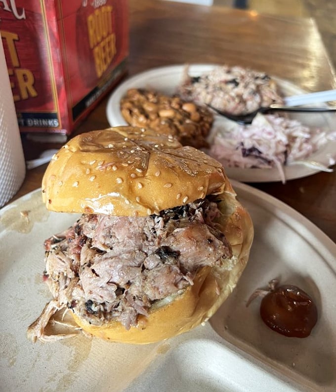 Pulled pork that actually maintains its dignity. No mushy, sauce-drowned mess here—just perfectly smoked strands cradled in a simple bun.