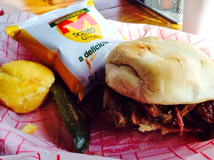 The pulled pork sandwich arrives with cornbread and chips—a holy trinity of comfort that makes you wonder why you'd eat anything else.