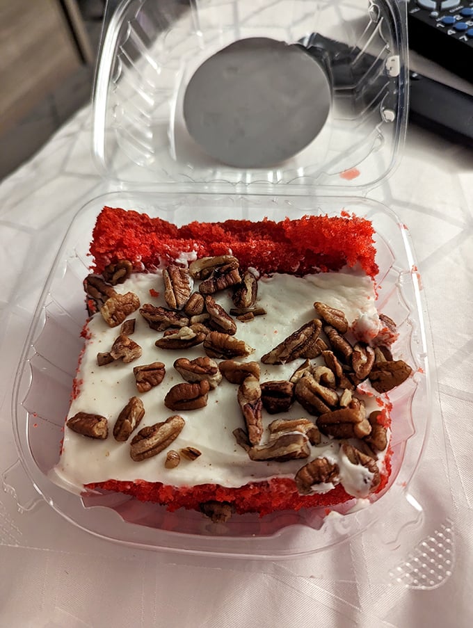 Red velvet cake with cream cheese frosting and pecans—because after conquering a mountain of barbecue, you deserve a dessert that's equally memorable. 