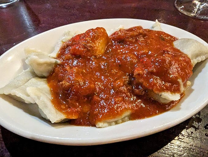 These ravioli aren't just pasta pockets – they're little envelopes delivering joy directly to your taste buds, swimming in a sea of robust sauce.