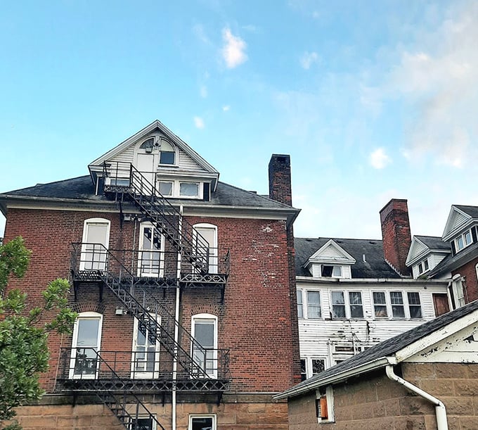 The seminary's fire escape zigzags dramatically against brick walls – an escape route that some residents likely dreamed of using.