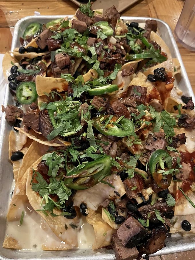 BBQ nachos that laugh in the face of subtlety – a glorious mess of smoked meat, jalapeños, and melted cheese that demands both napkins and respect.