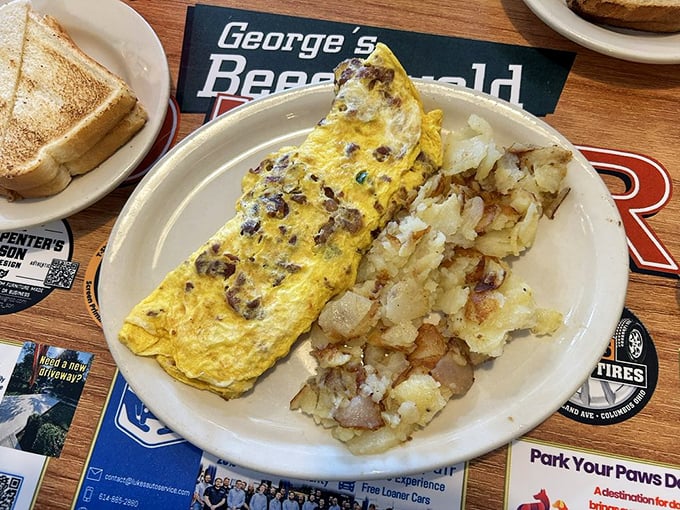 This omelet doesn't just contain ingredients—it showcases them, alongside home fries that could make a potato farmer weep with pride.