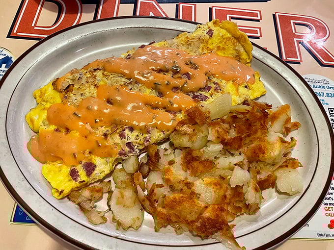 This isn't just an omelet – it's a masterpiece with a sauce so good you'll contemplate drinking it directly when nobody's looking.