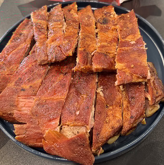 Behold, the carnivore's candy! These ribs wear their spice-crusted bark like badges of honor after hours in the smoker.