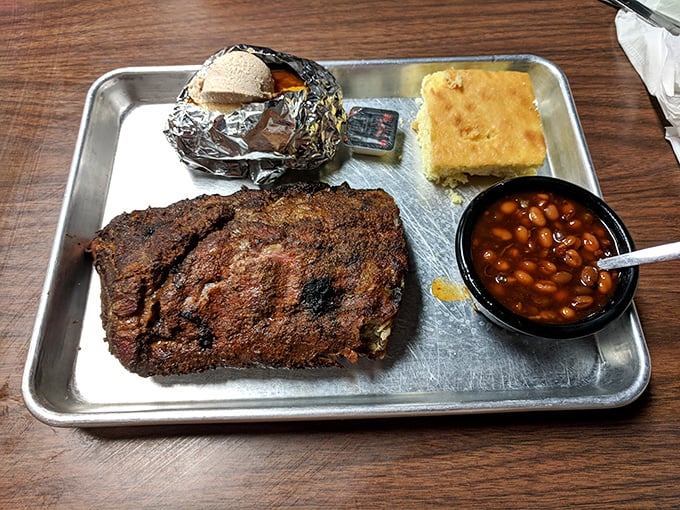 These ribs have clearly been on a long, meaningful journey with smoke and spice. That cornbread isn't just a side—it's an essential sauce delivery system.