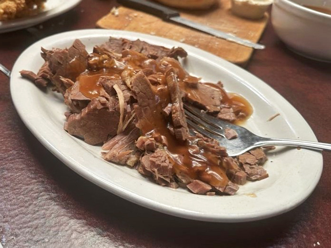 Roast beef so tender it practically surrenders to your fork, glistening in its own savory juices like a meaty spa treatment.