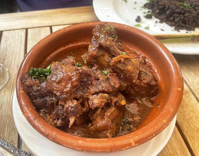 This ropa vieja doesn't just fall apart—it surrenders to your fork with the dramatic flair of a telenovela star, swimming in a sauce worth bottling.