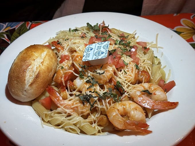 Shrimp and pasta dancing together in perfect harmony, like Fred Astaire and Ginger Rogers if they were delicious and served with a side of bread.