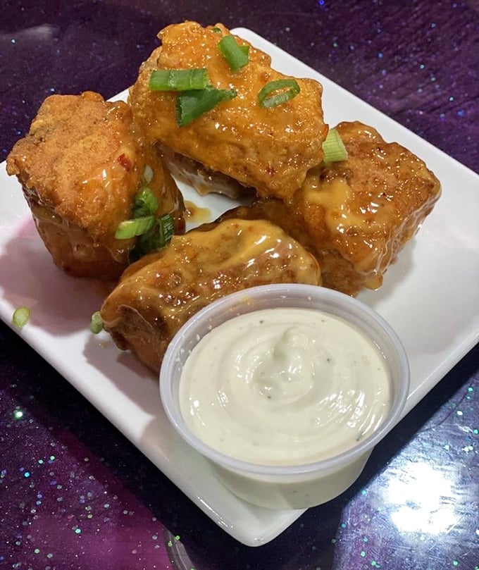 Golden salmon bites with a side of creamy sauce—proof that sometimes the best treasures come in small, perfectly fried packages.