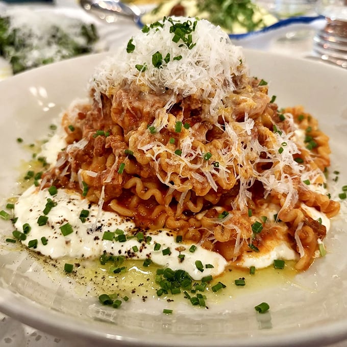 This pasta mountain with its crown of shaved cheese isn't just dinner—it's an edible architecture that deserves its own zip code in Flavortown.