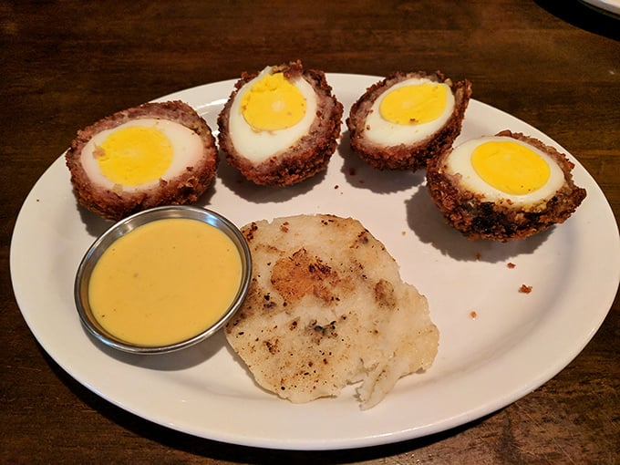 Scotch eggs that have clearly earned their PhD in comfort food – crispy exterior giving way to savory meat and that perfect yolk center. Diploma-worthy deliciousness.