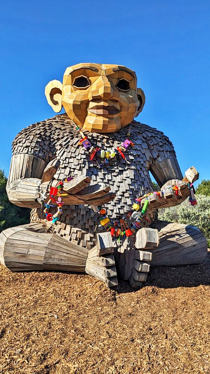 Meet the garden's most contemplative resident. This wooden giant seems to be pondering life's big questions while visitors add colorful locks to his meditation beads.
