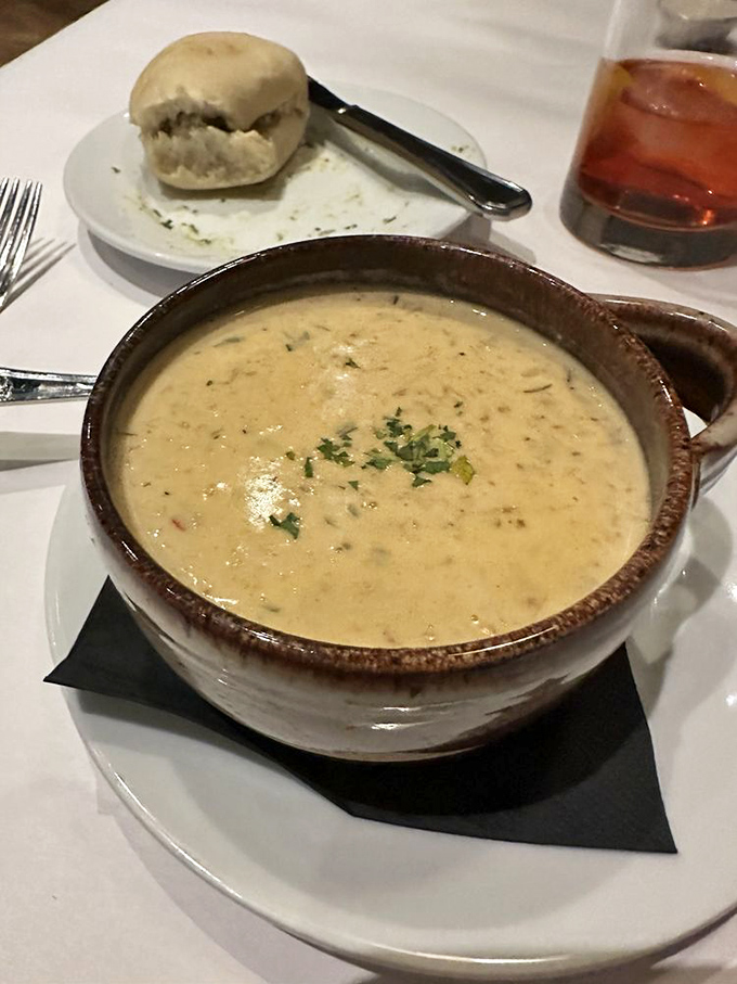 A seafood bisque so velvety and rich it deserves its own trust fund. That roll isn't just a side – it's essential equipment for capturing every last drop.