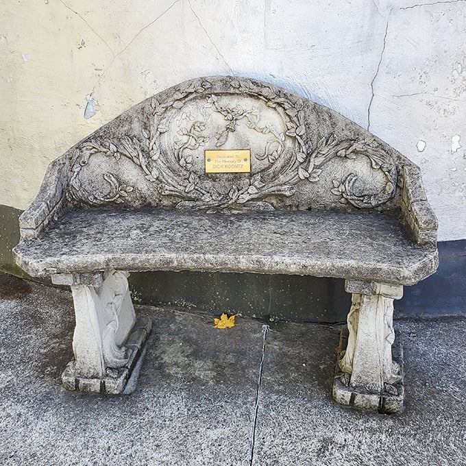 This ornate stone bench offers weary travelers a moment to contemplate life's big questions—like "Who builds a building shaped like a coffee pot?"