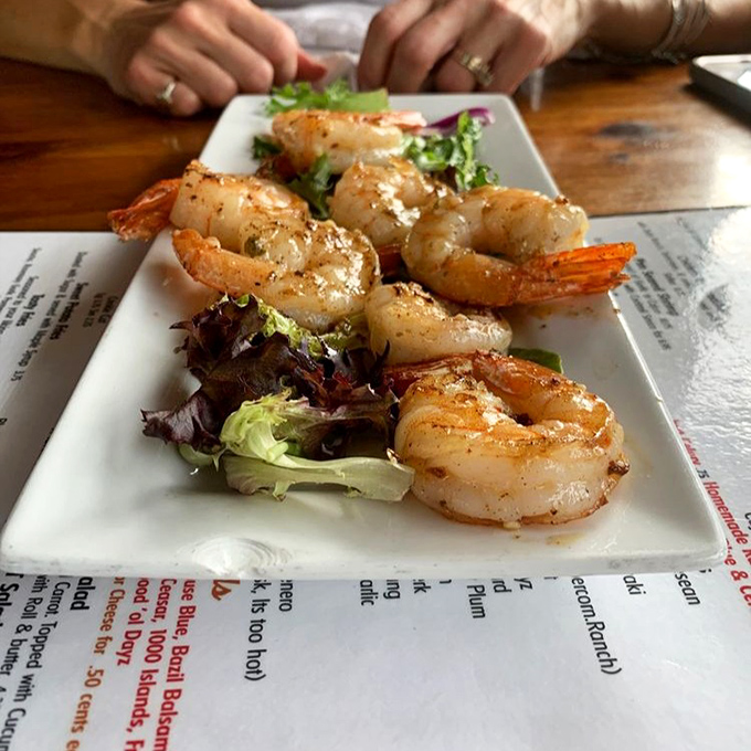 These aren't just shrimp—they're plump little flavor vessels perched atop fresh greens, waiting to transport you to coastal bliss in landlocked Ohio.