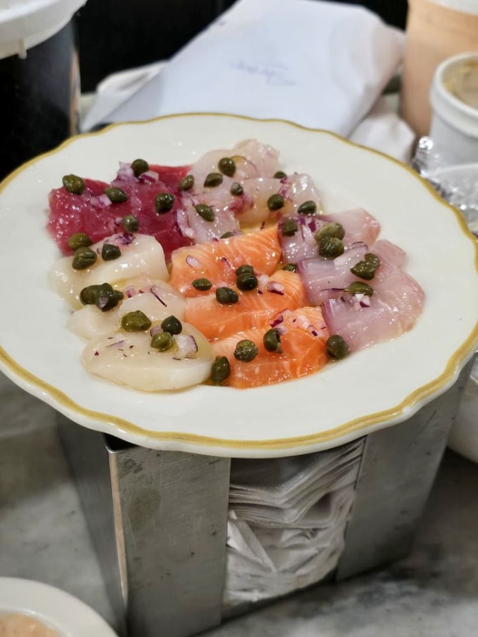 Sicilian sashimi – a colorful mosaic of the ocean's finest, adorned with capers and olive oil. Who needs cooking when raw perfection exists?