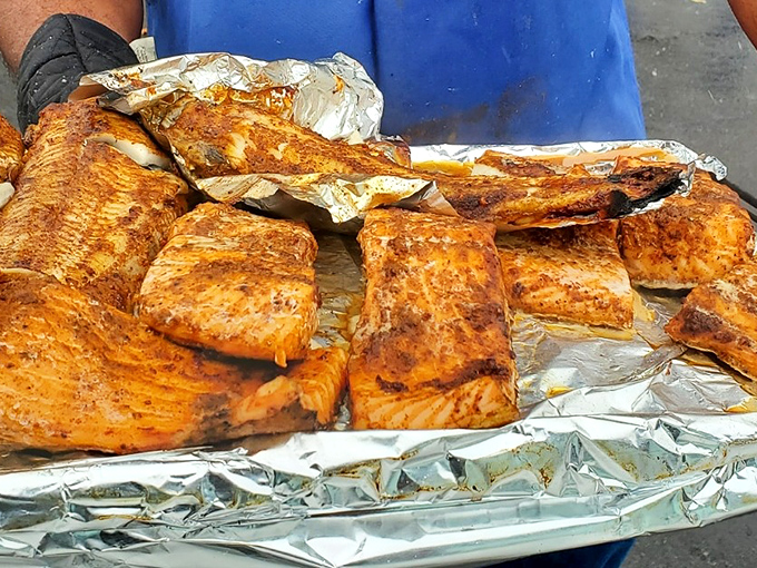 Smoked salmon glistening on foil like edible treasure, seasoned and ready to change your whole afternoon's trajectory.