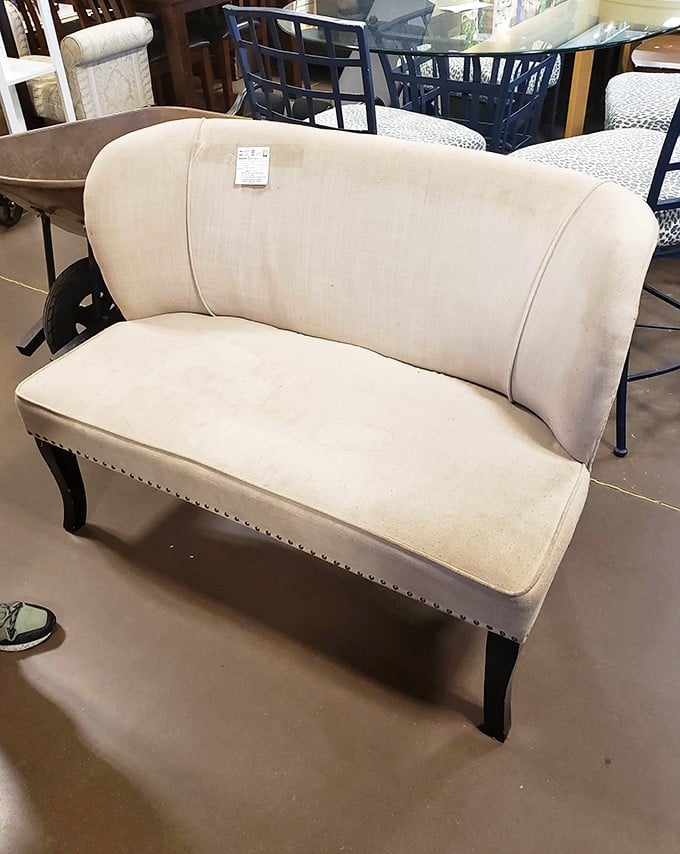 This elegant cream settee isn't just furniture—it's a statement piece with stories to tell. Imagine the conversations it could host in your living room.