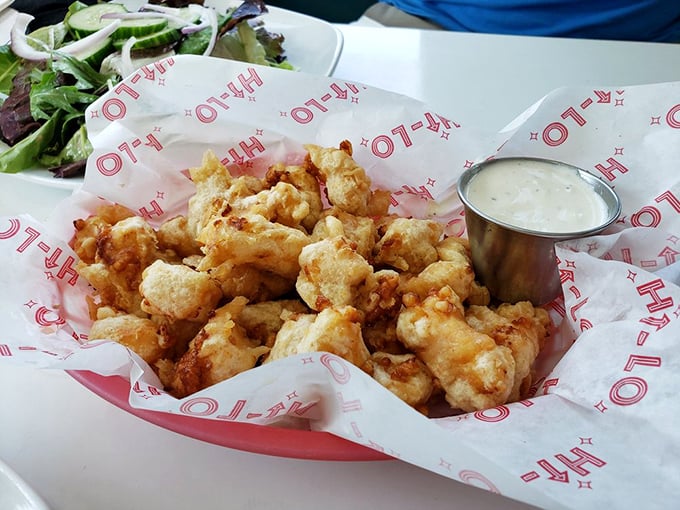 These cheese curds aren't just fried—they're transformed into crunchy little clouds of dairy perfection. The dipping sauce is merely a bonus round.