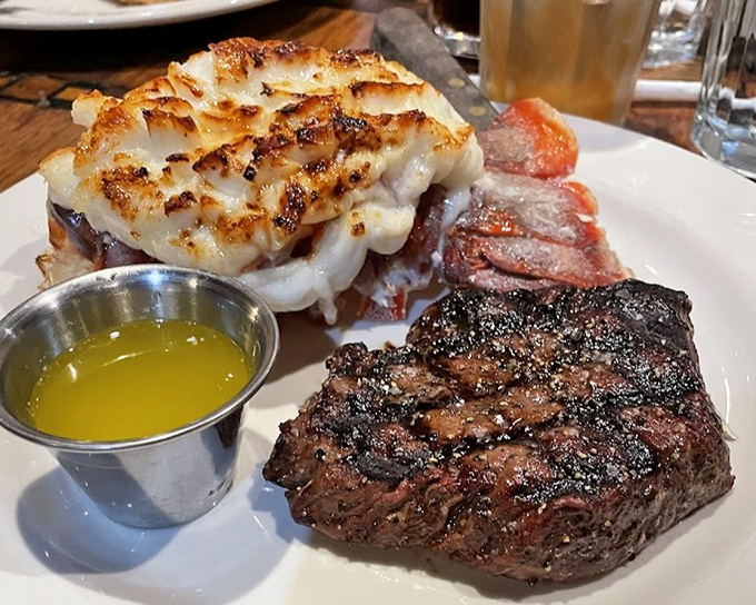 The ultimate land-and-sea compromise: a perfectly grilled steak playing wingman to a lobster tail that clearly dressed up for the occasion.