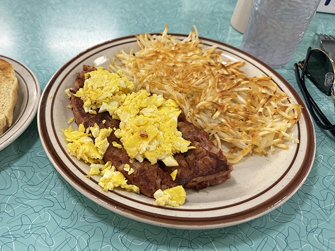 Breakfast of champions: perfectly seasoned steak tips topped with scrambled eggs alongside hash browns that achieved the impossible – both crispy and tender.