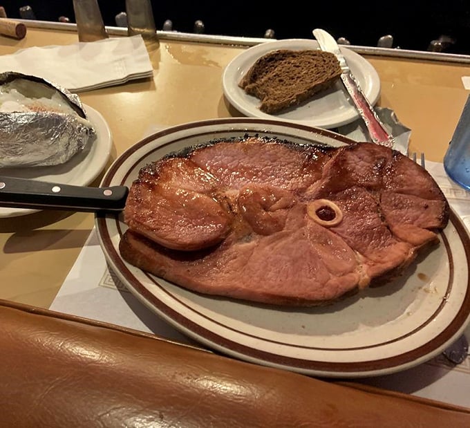 The ham steak arrives like a carnivore's dream—substantial, perfectly seared, and ready to transport you to comfort food paradise.