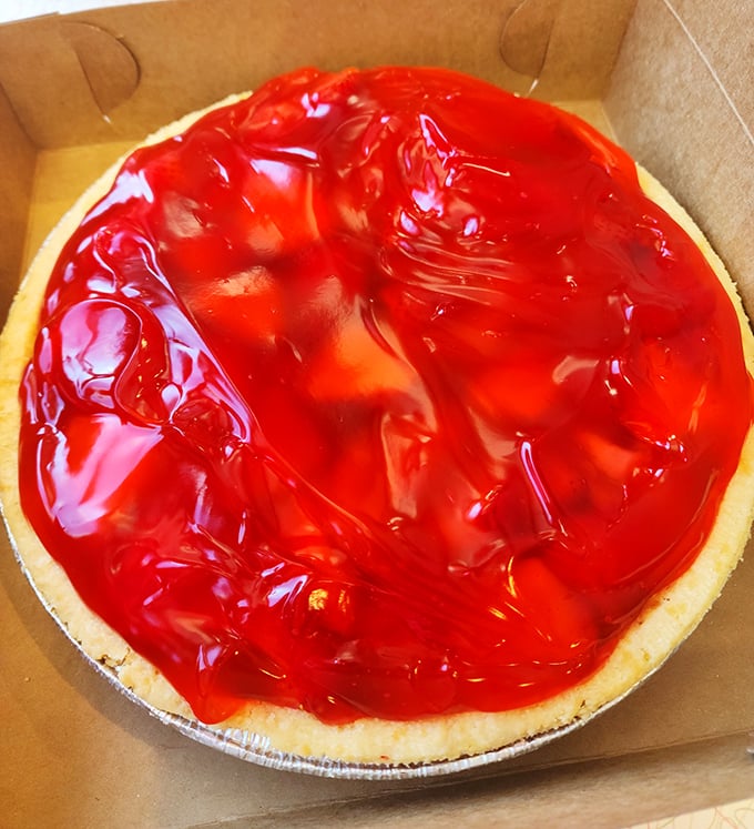 Behold the crown jewel of Midwestern desserts – a strawberry pie glistening with that signature glaze that somehow makes fruit count as comfort food.