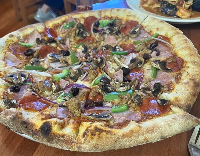 Pizza this loaded should come with a structural engineering degree – just look at that glorious chaos of toppings.
