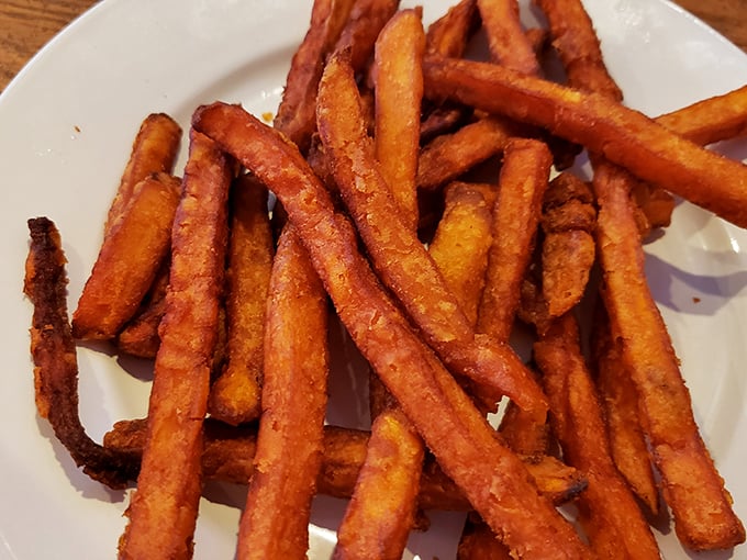 Sweet potato fries that achieve the impossible: perfectly crisp exteriors giving way to tender, sweet interiors – the Goldilocks of side dishes.