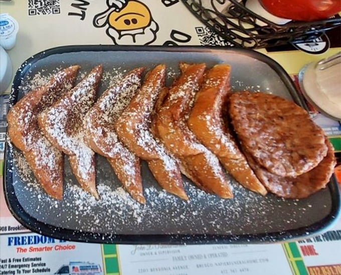 French toast that's dressed for success—powdered sugar snowfall on golden-brown perfection that makes ordinary bread feel like royalty.