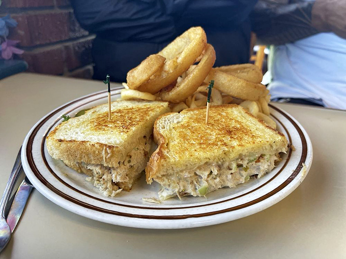 A tuna melt that would make the Fonz snap his fingers in approval—golden-brown, crispy outside, creamy tuna goodness inside, with fries standing at attention.