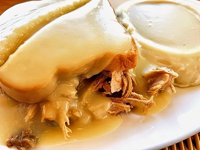 The Turkey Manhattan – where tender turkey and homemade gravy transform bread into a throne worthy of Thanksgiving royalty.